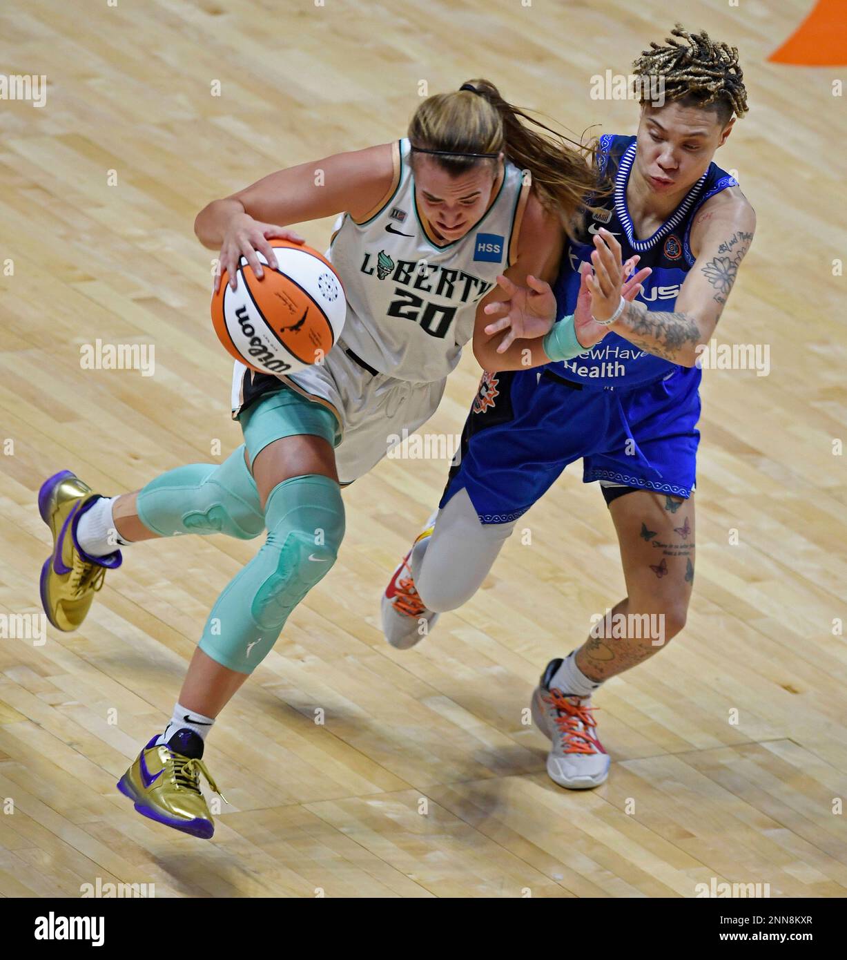 New York Liberty's Sabrina Ionescu (20) fends off Connecticut Sun's ...
