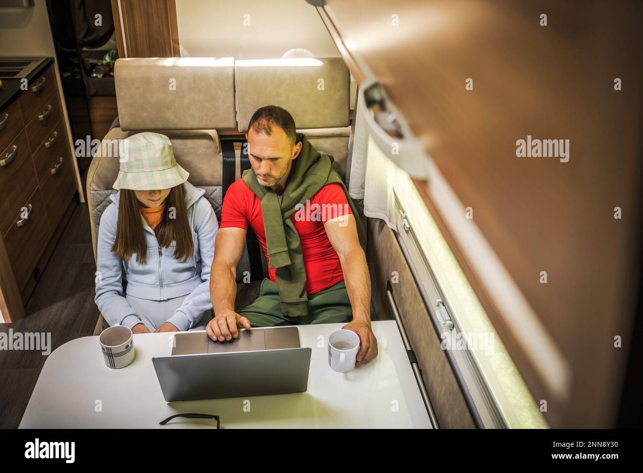 Top View of Father and Daughter Sitting Inside Modern RV Staring at ...