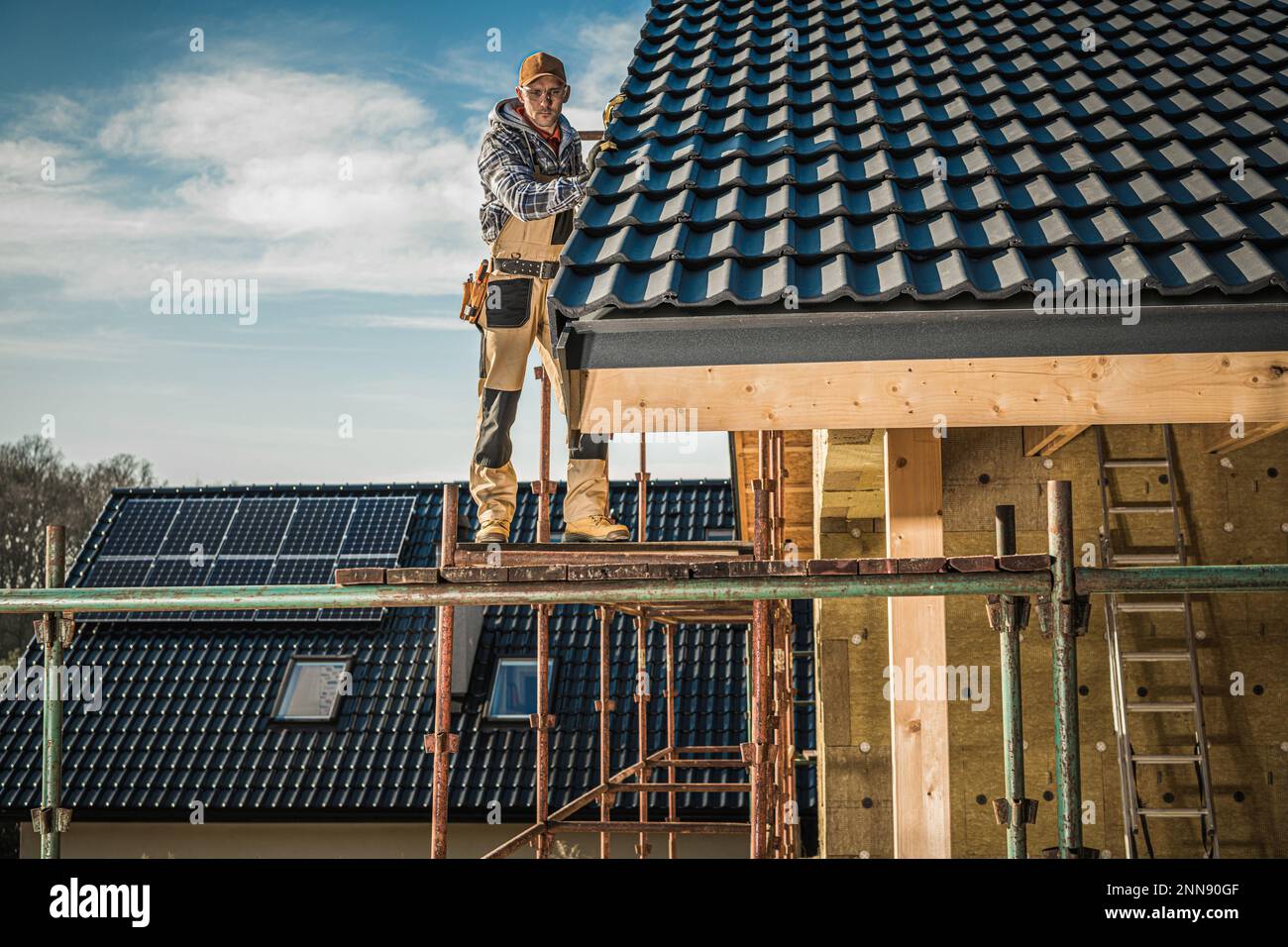 Professional Contractor Working on Roof Installation at Residential ...