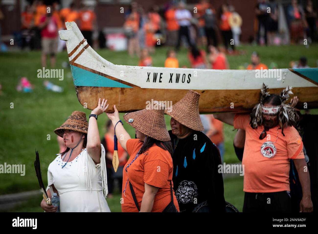 People from the Sto:lo Nation carry a canoe after a ceremony to lead ...