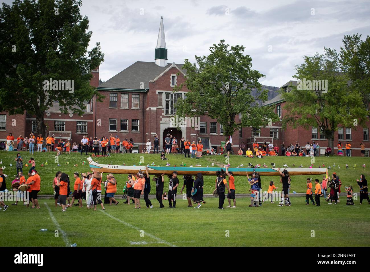 People from the Sto:lo Nation carry a canoe after a ceremony to lead ...