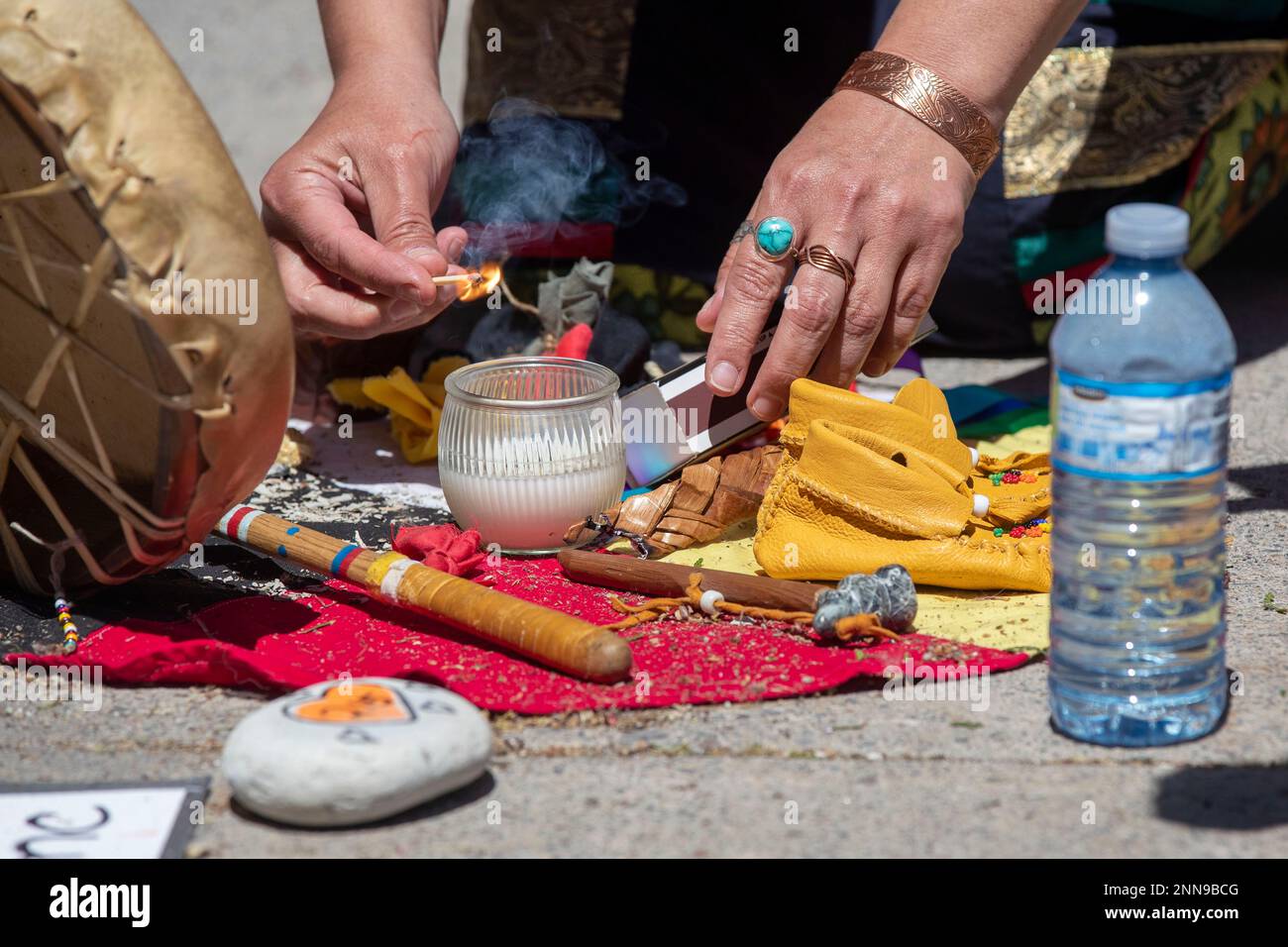 A person starts some tobacco for smudging before ceremony in Kingston ...