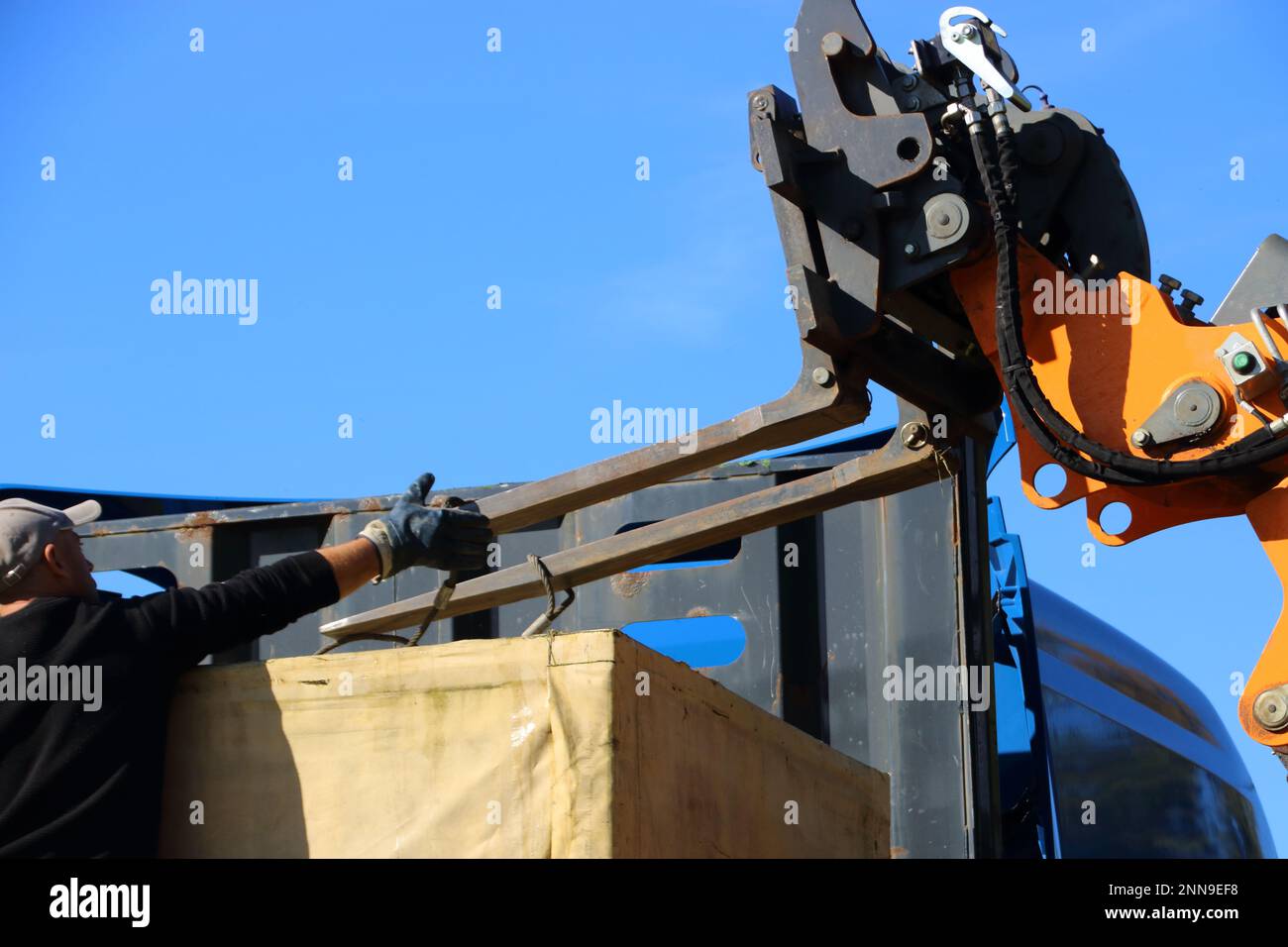Loading a crate with a forklift Stock Photo - Alamy