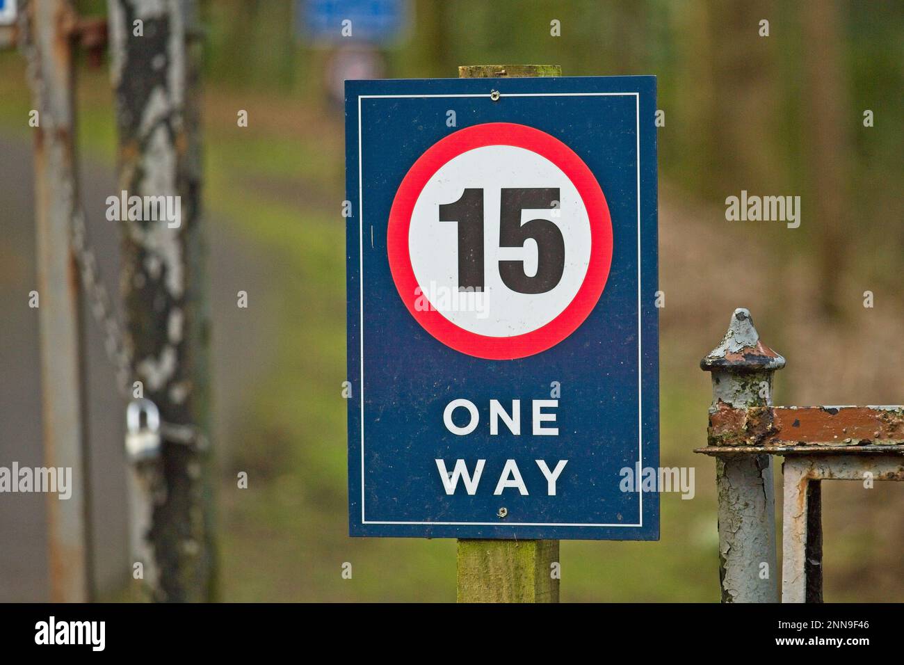 15 MPH and One Way sign on a blue board background Stock Photo - Alamy