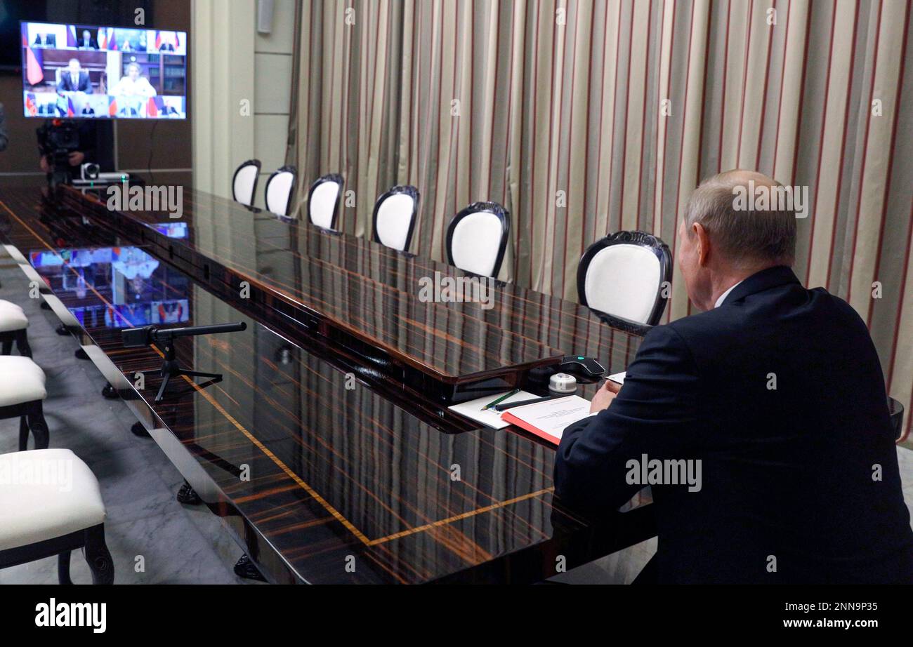Russian President Vladimir Putin leads a meeting via video conference ...