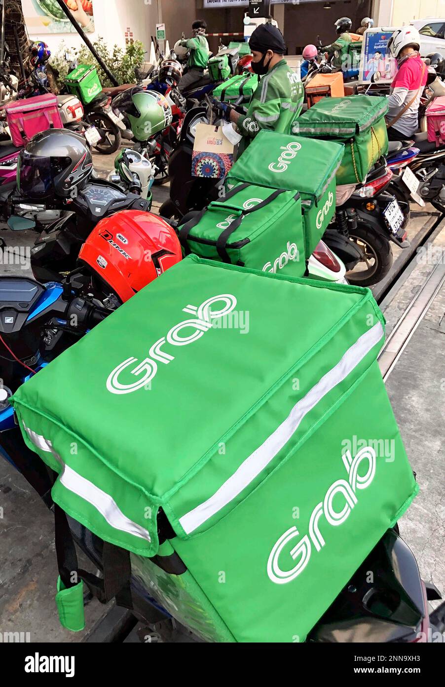 Motorbikes of Grab park in front of a large commercial complex in ...