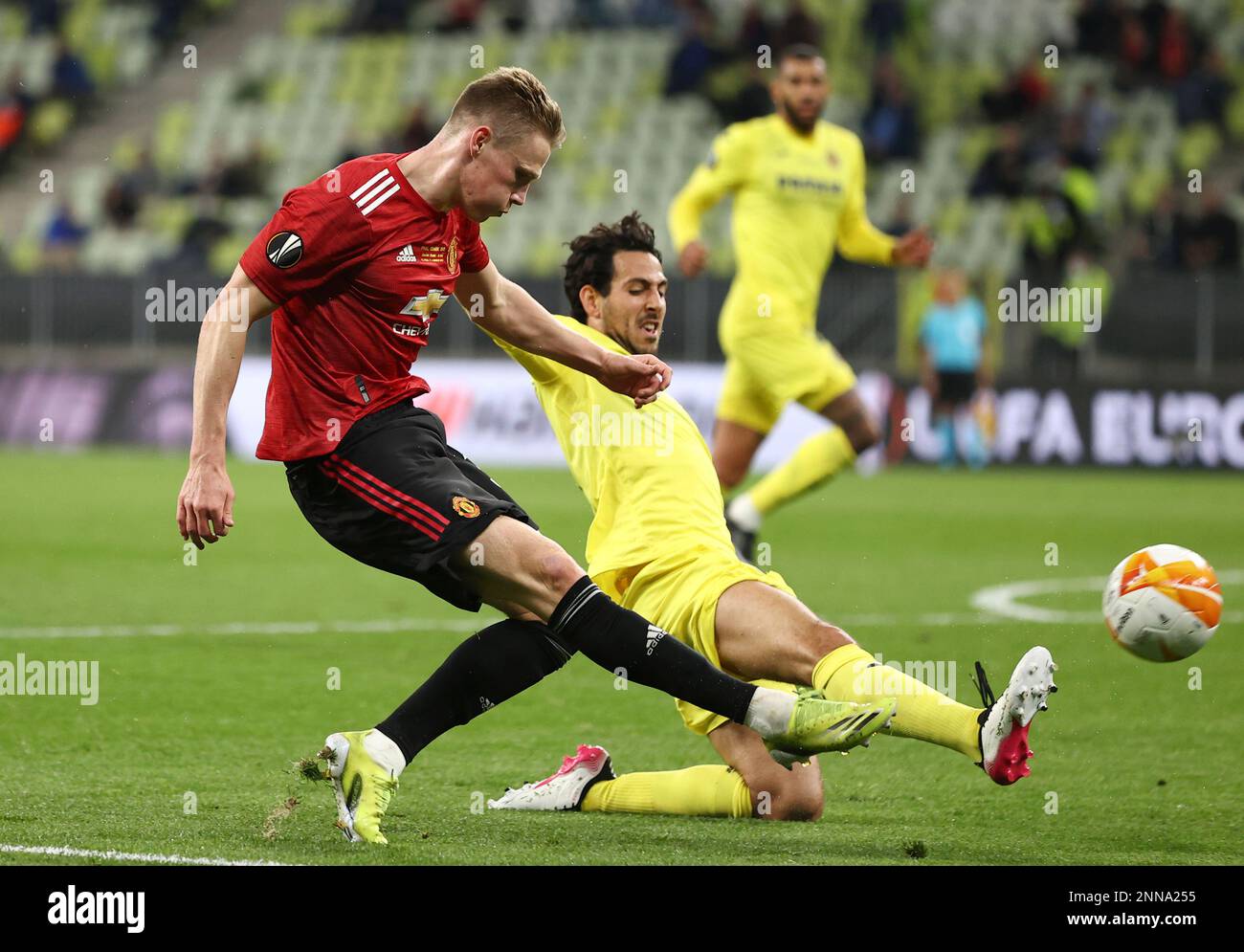 Manchester United's Scott McTominay, left, kicks the ball past ...