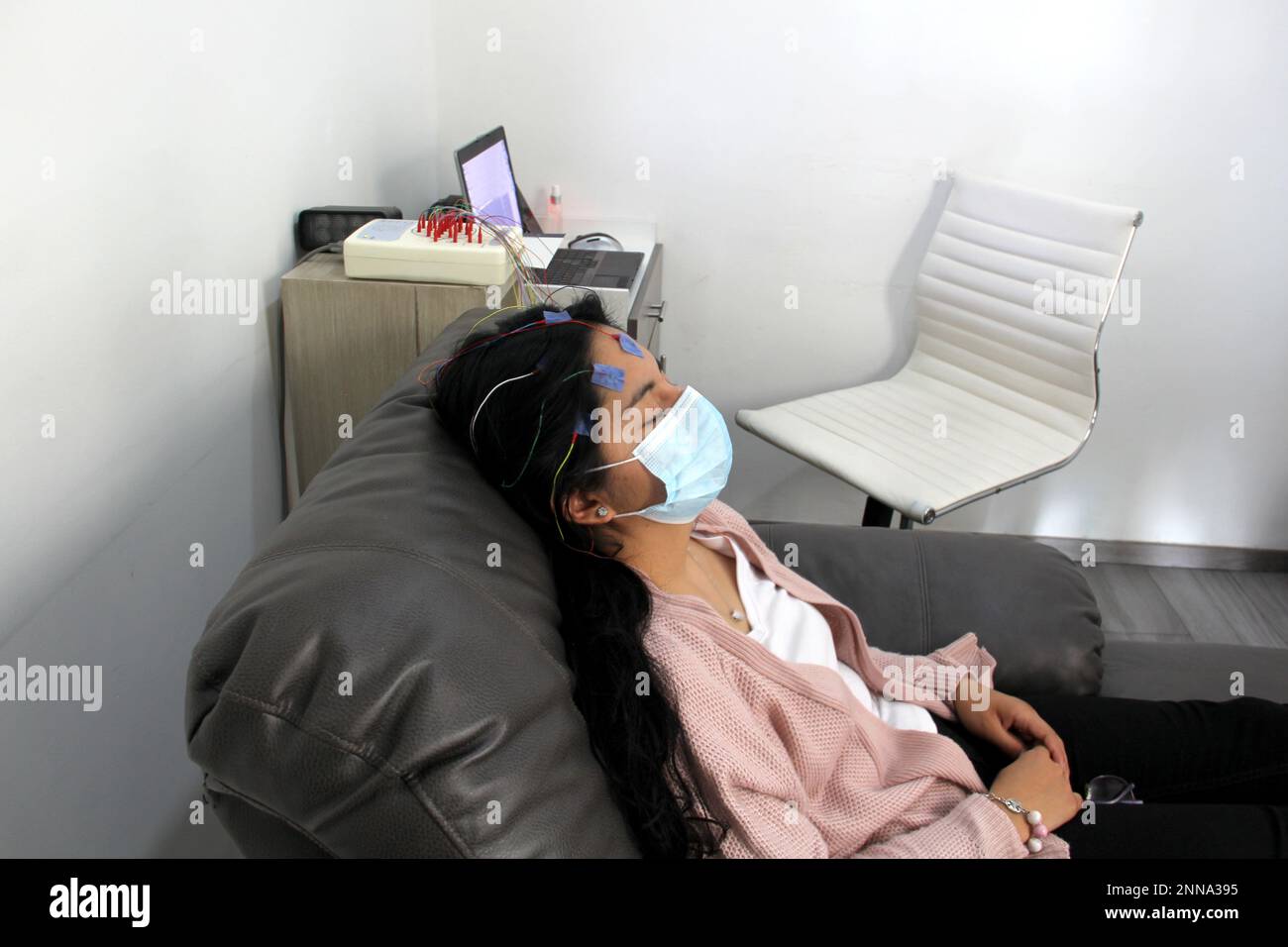 Latin woman with protection mask in medical tests, electroencephalogram ...