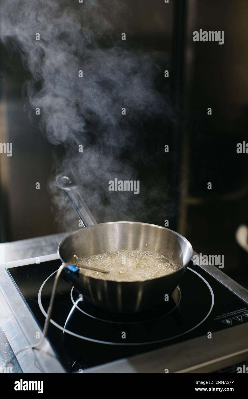 Cooking caramel in a saucepan on inductive cooking surfaces Stock Photo ...