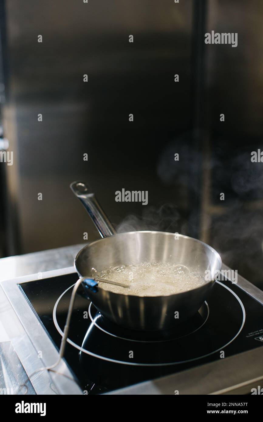 Cooking caramel in a saucepan on inductive cooking surfaces Stock Photo ...