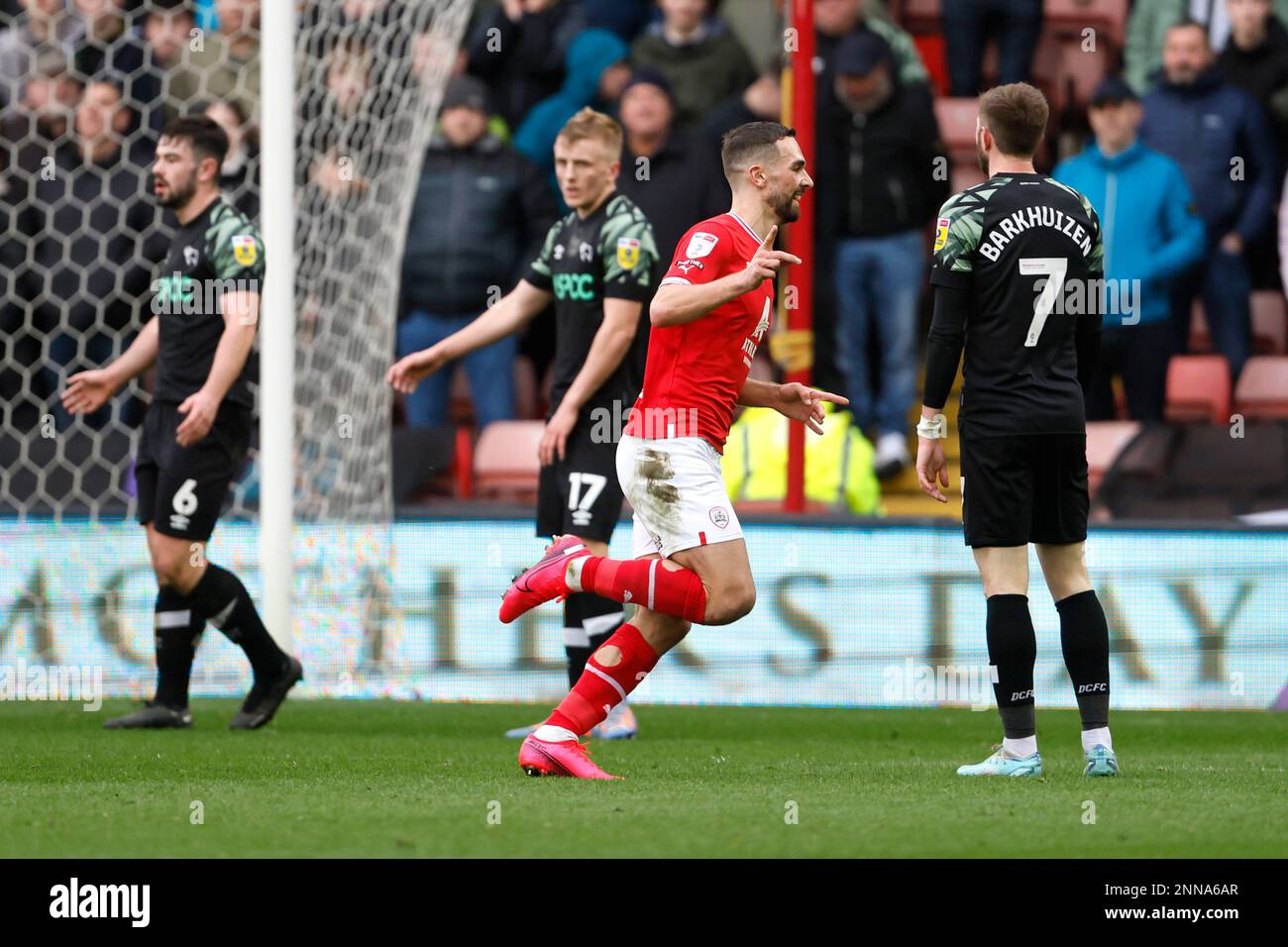 Barnsley's Adam Phillips (centre) celebrates scoring their side's ...