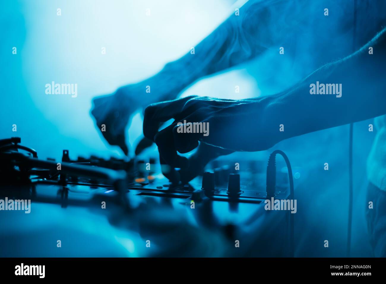 Disc jockey mixing music set on stage in nightclub. Club DJ playing ...