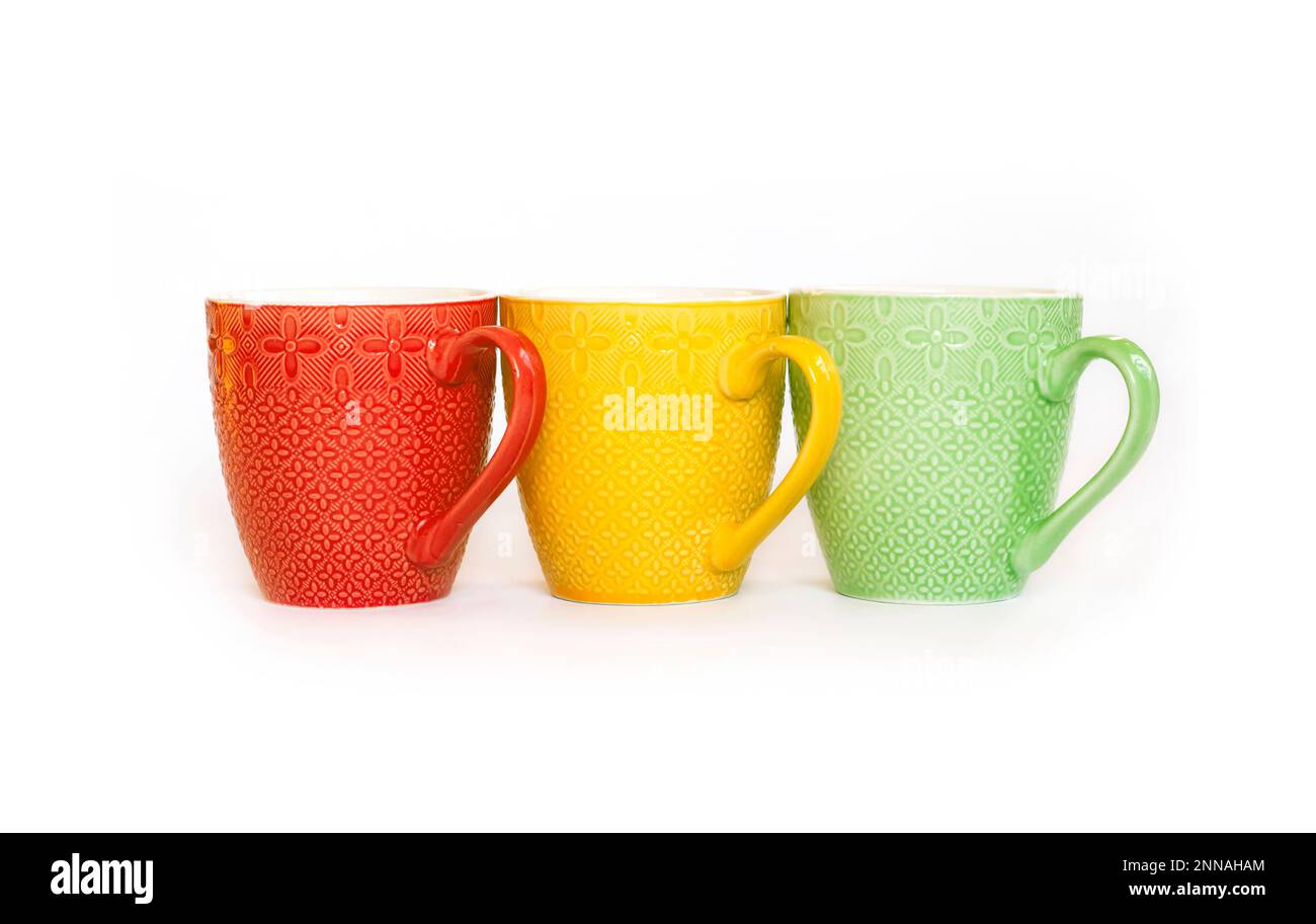Three colorful mugs isolated on white background Stock Photo - Alamy