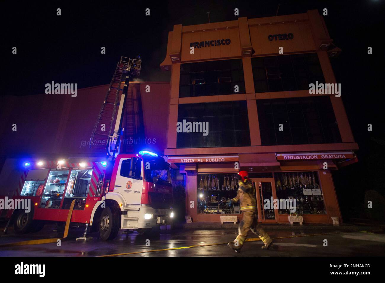 Firefighters Work To Extinguish The Fire Affecting An Industrial
