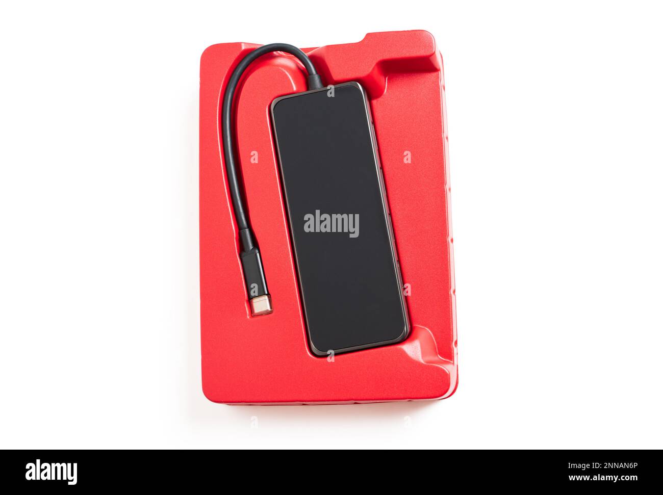 Black metal usb-c hub adapter in a red plastic retail package isolated ...