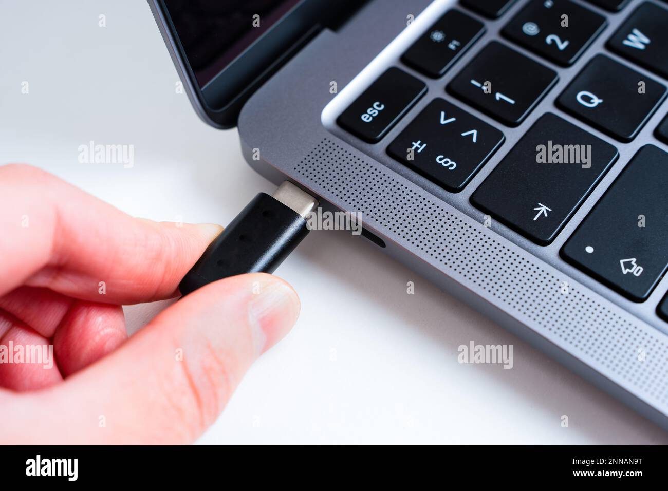 Illustrating the process of connecting devices to a laptop: hand ...