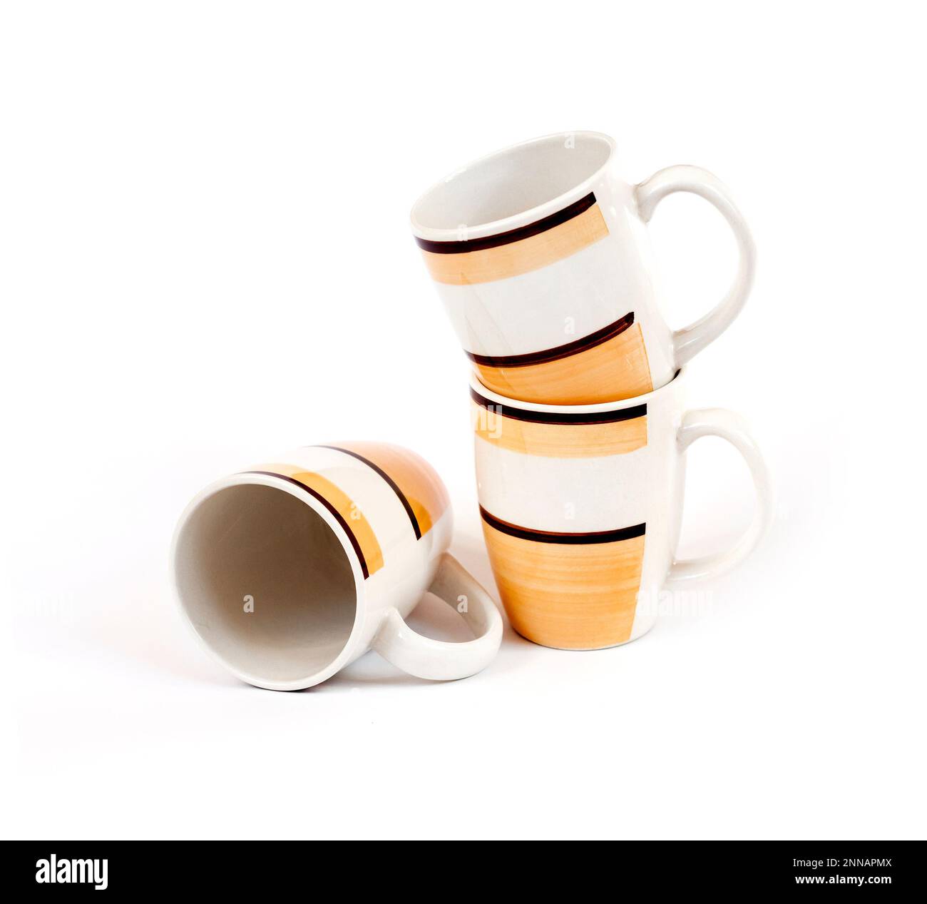 Stack of three mugs isolated on white background Stock Photo - Alamy