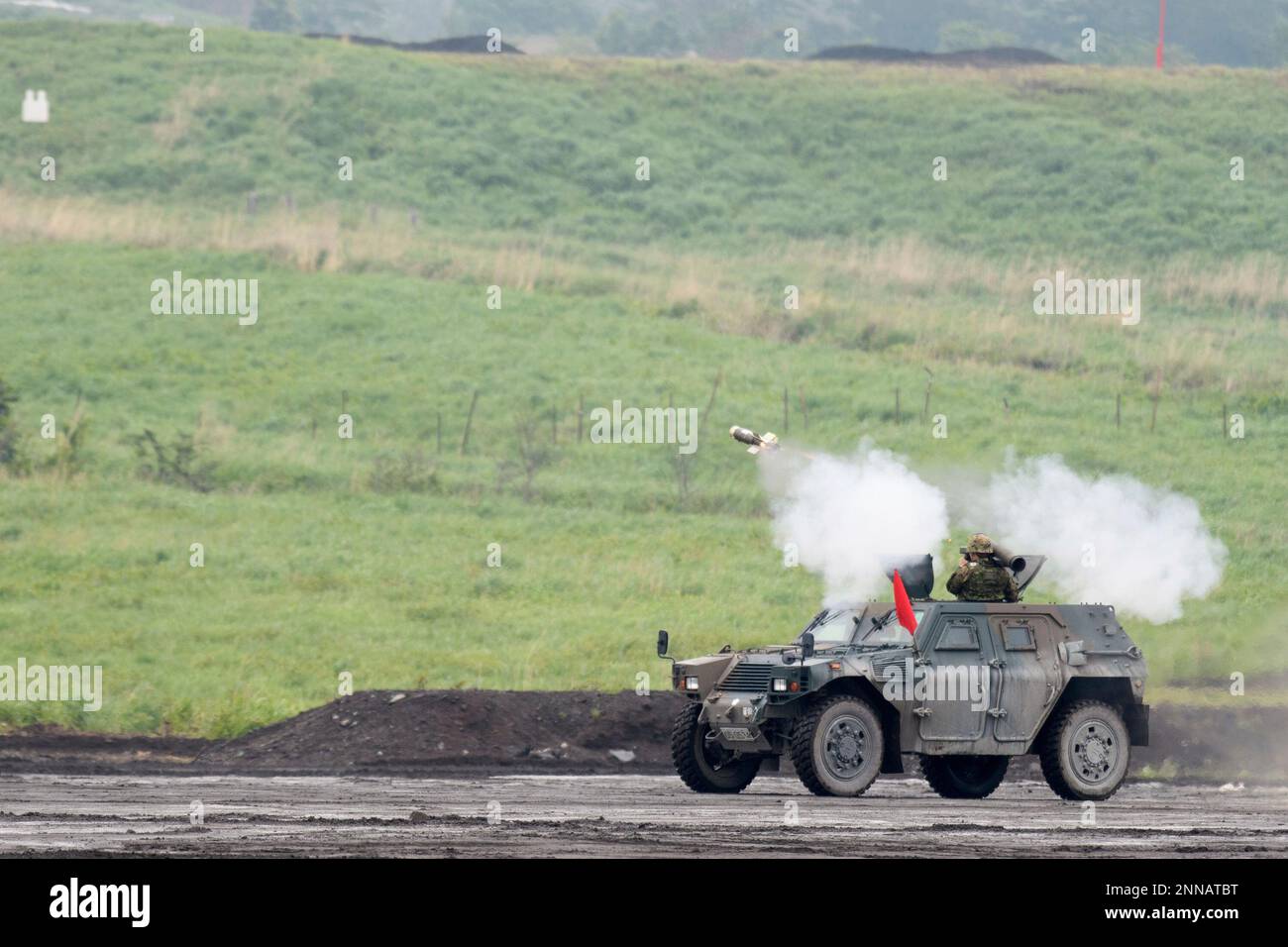 Japan's Ground Self-Defense Forces (JGSDF) soldier fires a weapon from ...