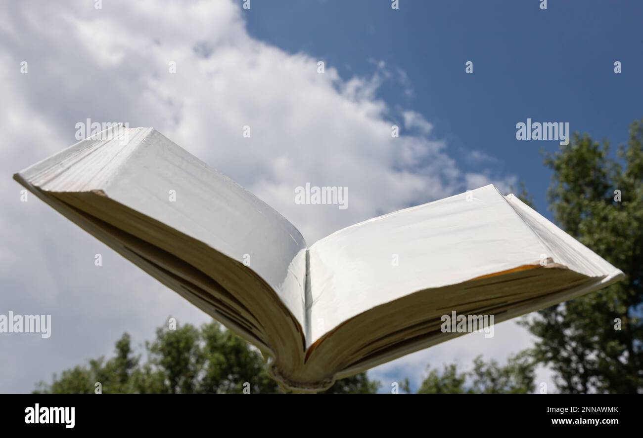 blank white open book on sky background Stock Photo - Alamy