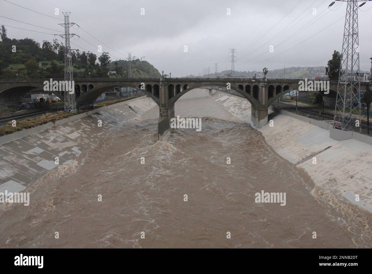 The rain-swollen Los Angeles River flows near downtown Los Angeles on ...