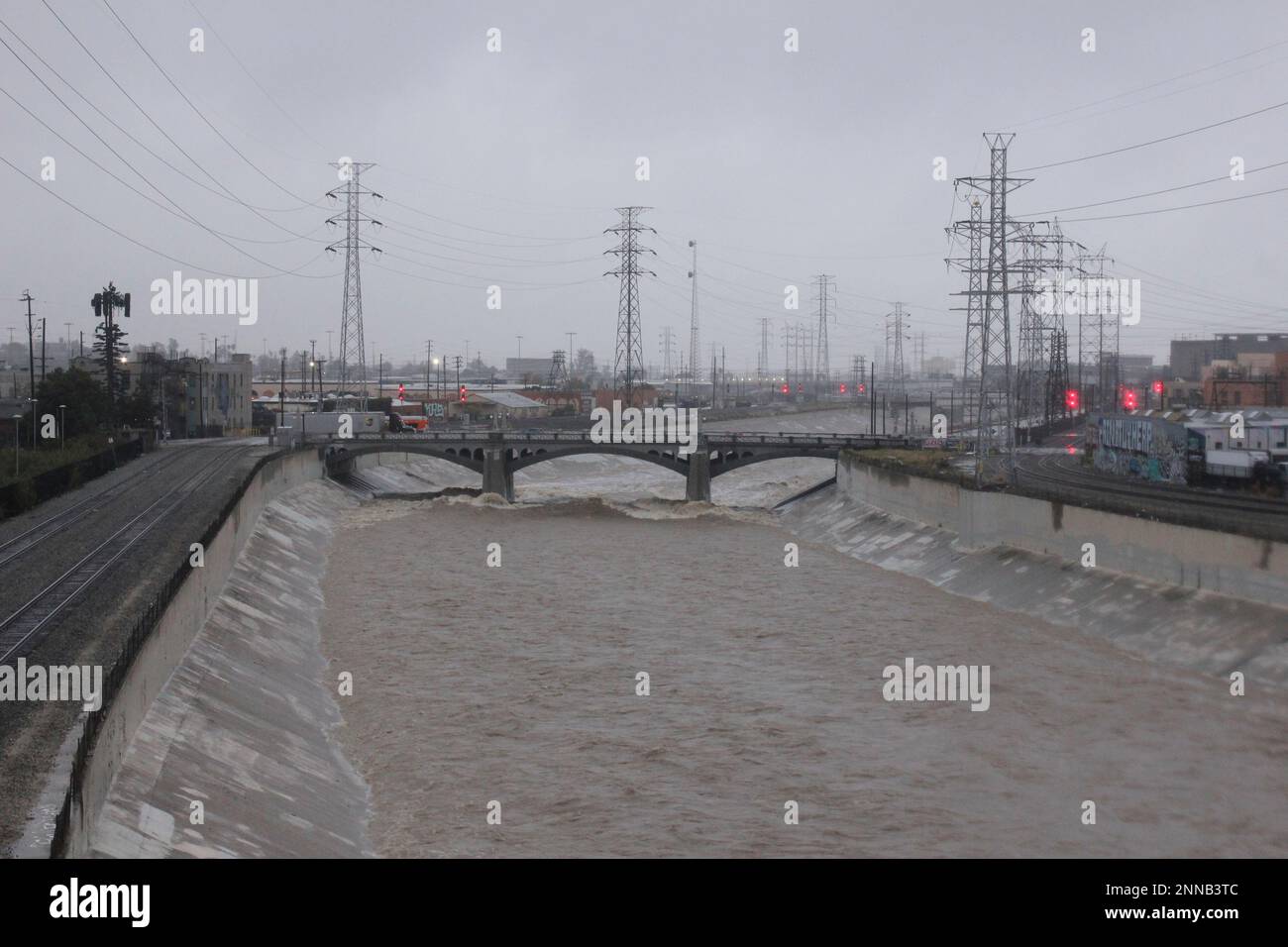 The rain-swollen Los Angeles River flows near downtown Los Angeles on ...