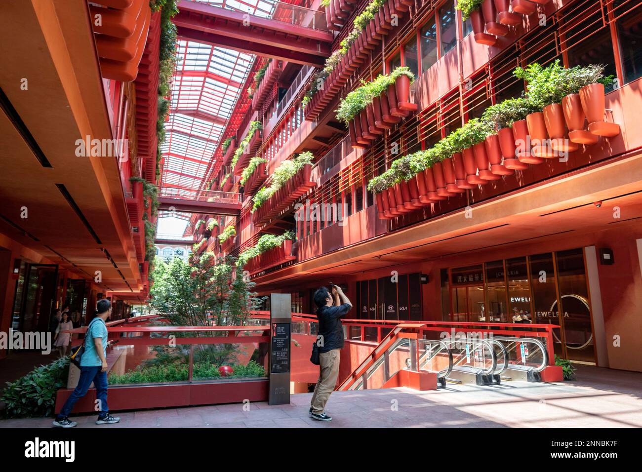 A visitor takes photos of the new shopping complex The Roof, designed by French architect ...