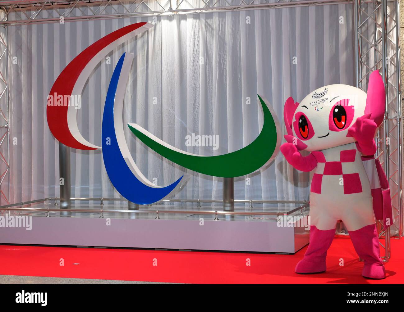 The Paralympic symbol, three "agitos" (Latin for "I move") is shown ...