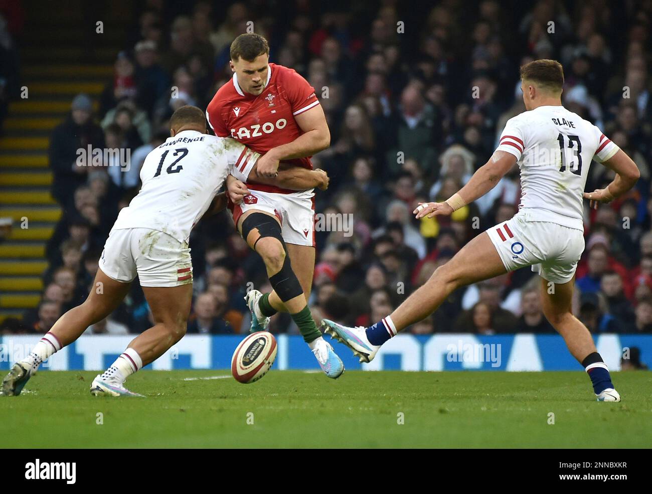Wales Mason Grady, centre, is tackled by England's Ollie Lawrence, left, during the Six Nations ...
