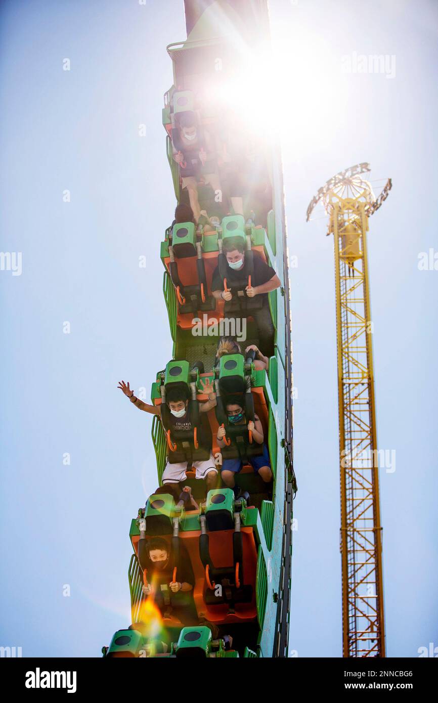 People ride Brain Drain during opening day at Elitch Gardens in Denver ...