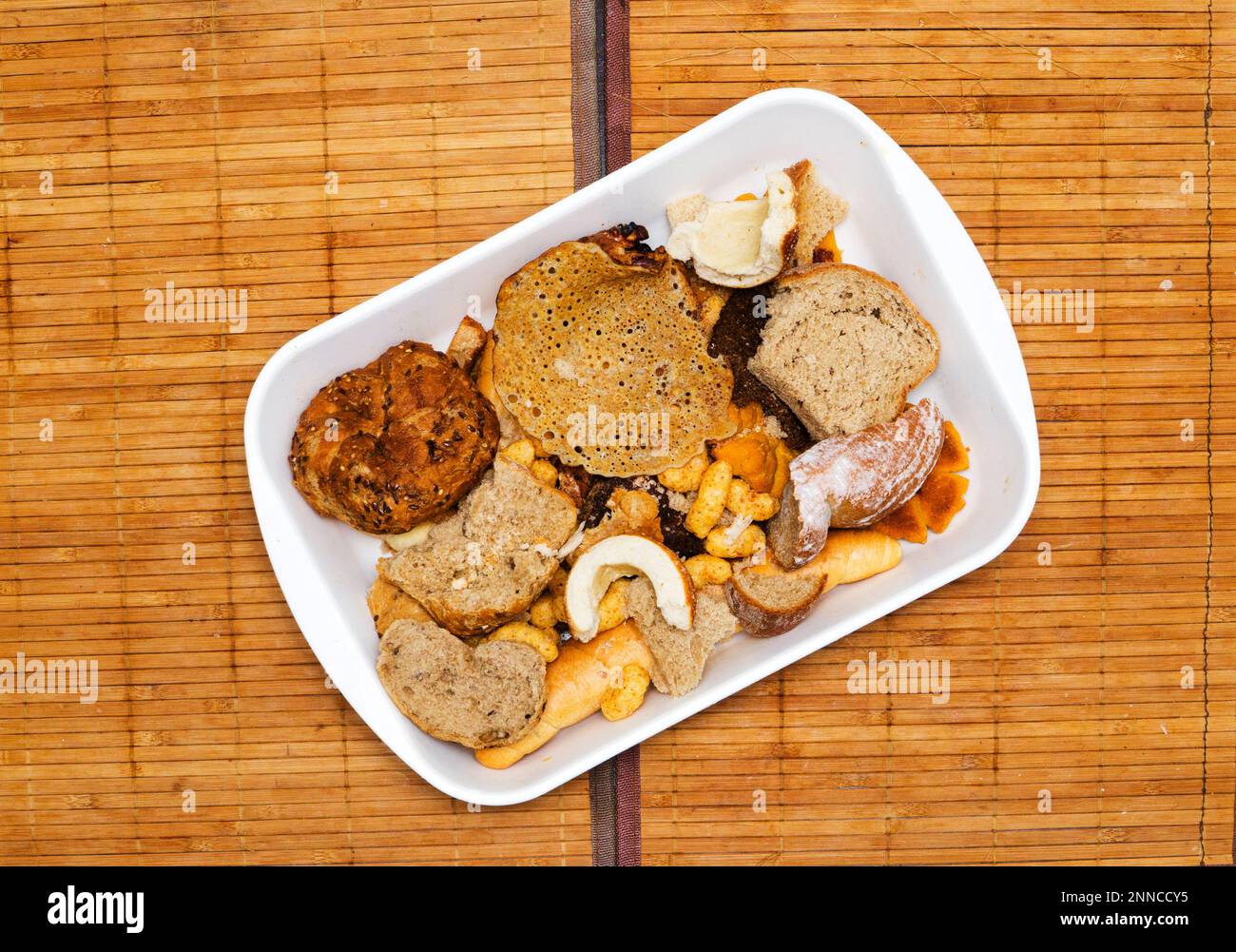 Pile of many slices of stale bread and other stale baked goods. Tossing ...