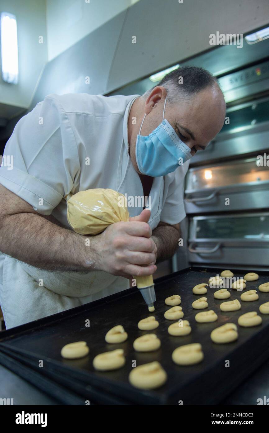 The pastry chef prepares the typical San Isidro doughnuts with a pastry ...