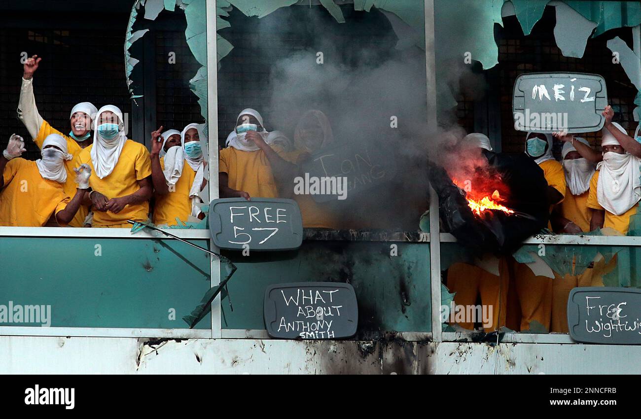 FILE - In this Feb. 6, 2021, file photo, inmates yell from broken ...