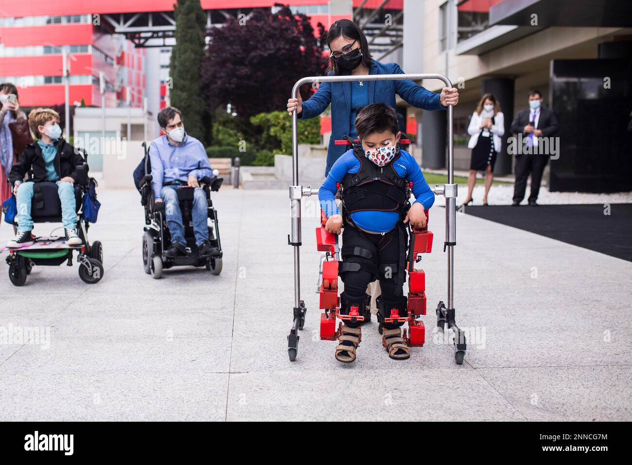 The Atlas project leader, Marie Destarac, carries with the exoskeleton Victor Millo, a 6-year ...