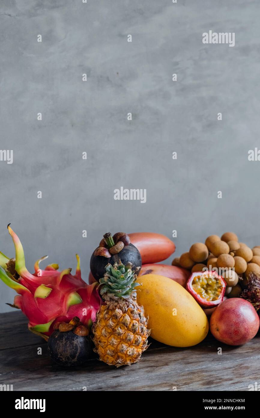Still life with asian fruits. Set of colorful fruits. Dark photo ...