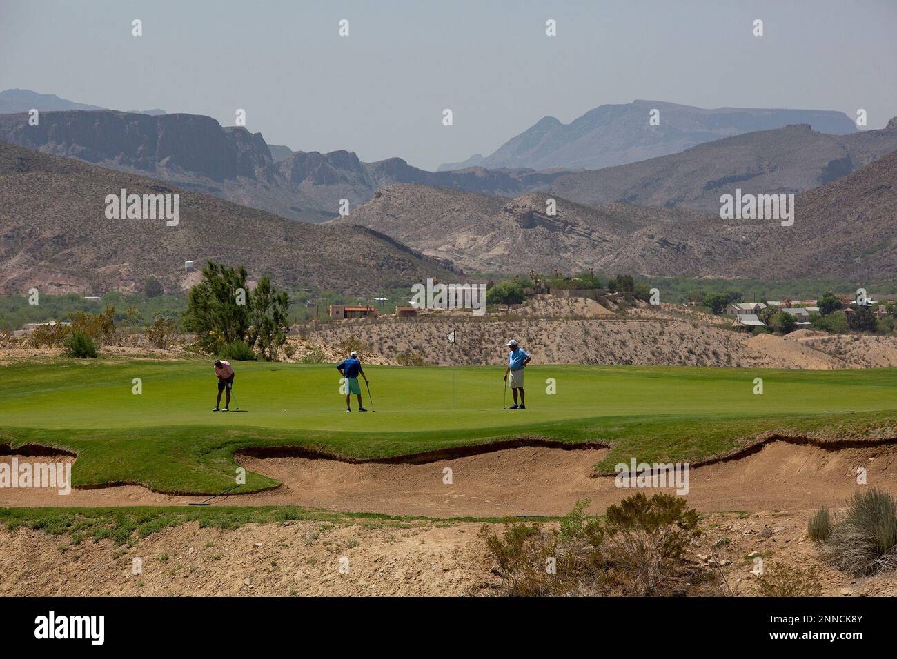 Pete Moss, left, putts on the green of hole 7 at Black Jack's Crossing ...