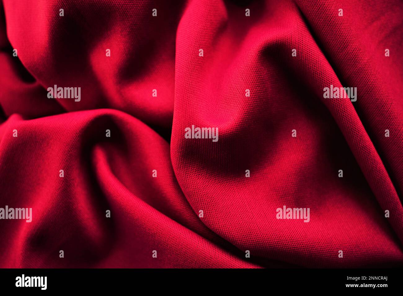 Vivid red crumpled elastic fabric background Stock Photo - Alamy