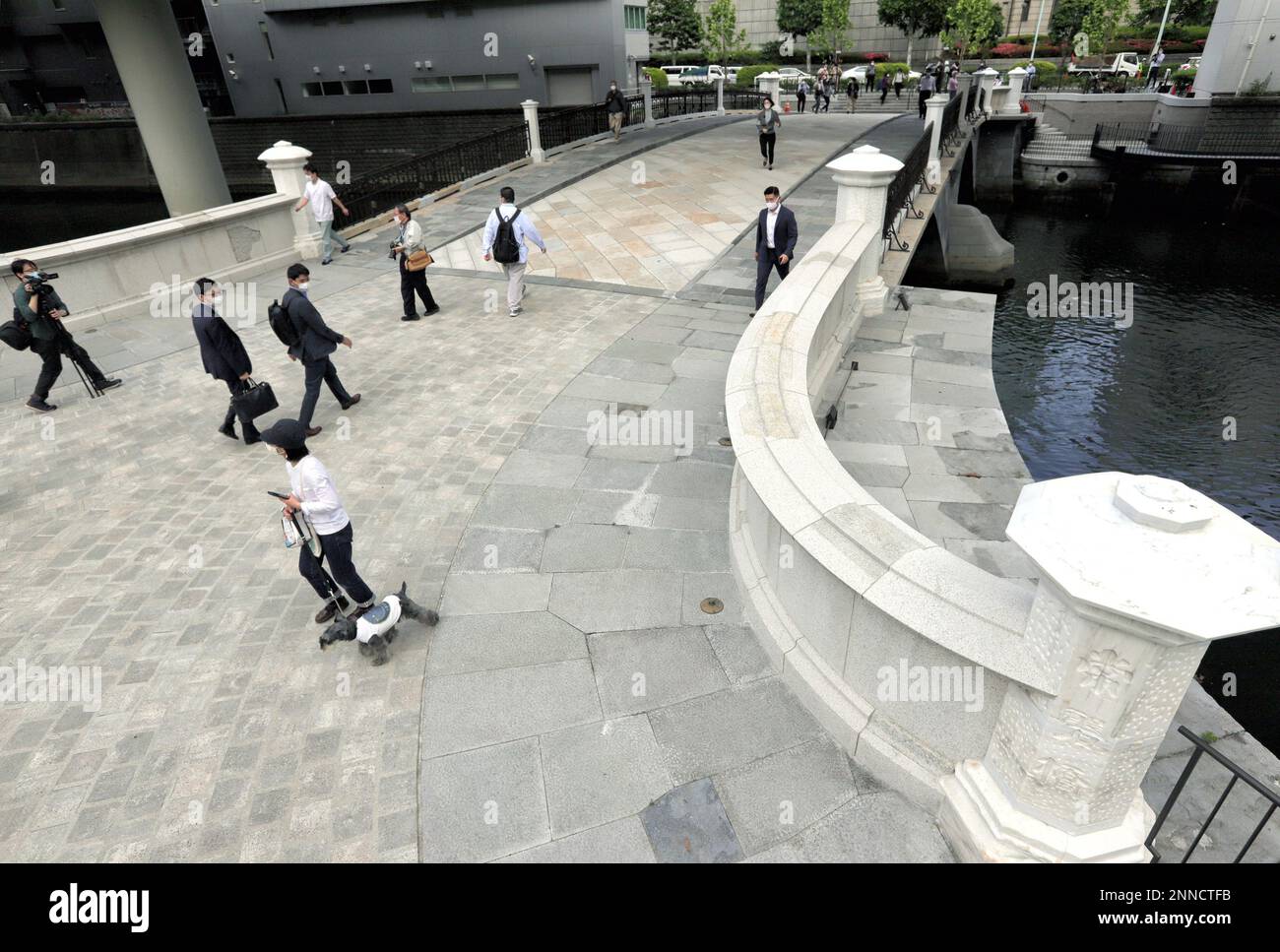 Pedestrians walk on the Tokiwa Bridge, which has been renovated after a ...