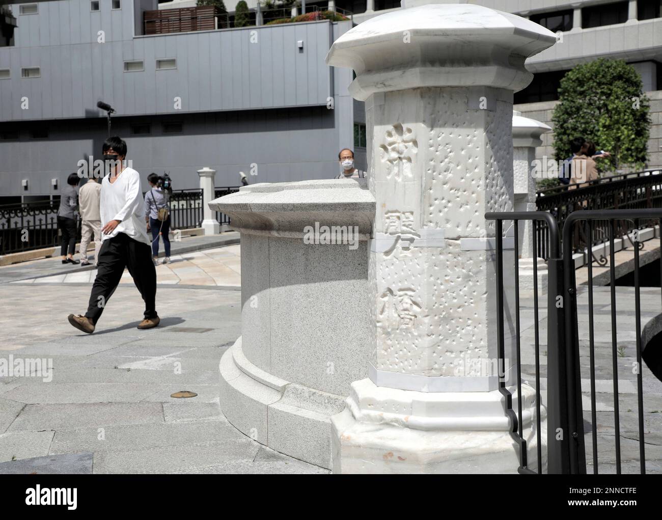 Pedestrians walk on the Tokiwa Bridge, which has been renovated after a ...