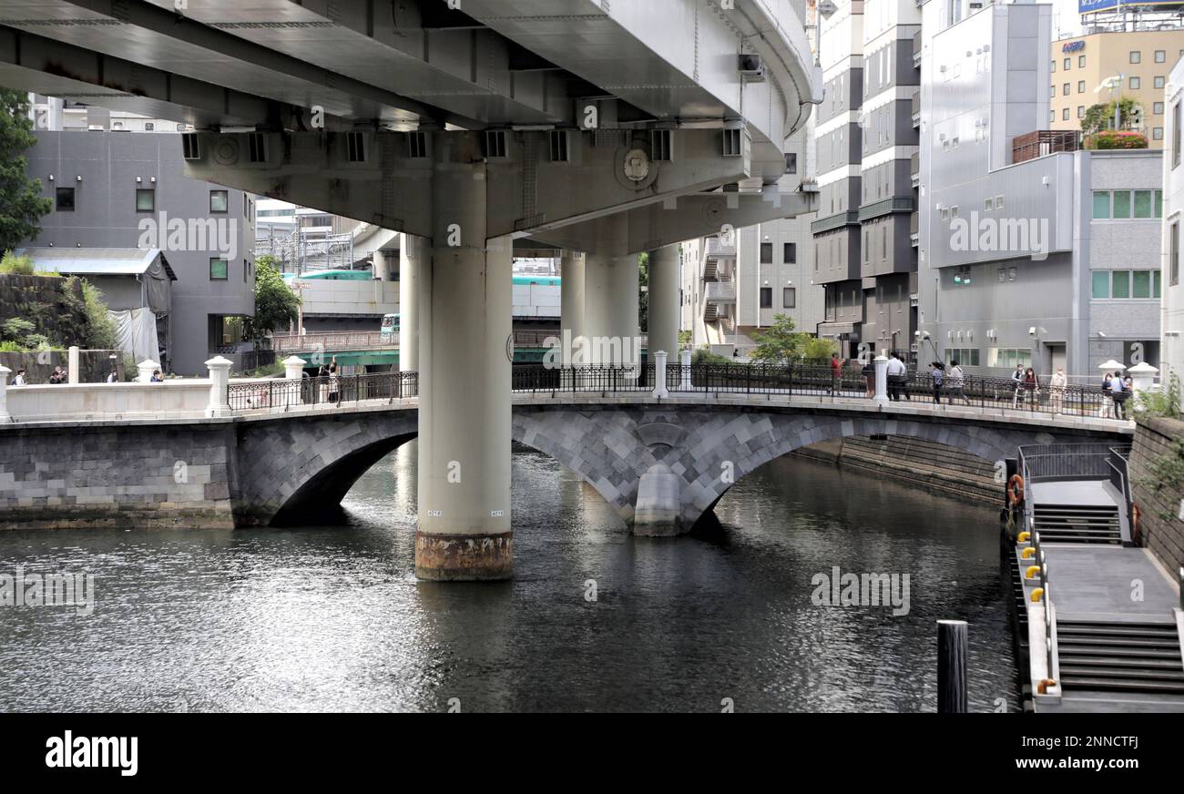 Pedestrians walk on the Tokiwa Bridge, which has been renovated after a ...