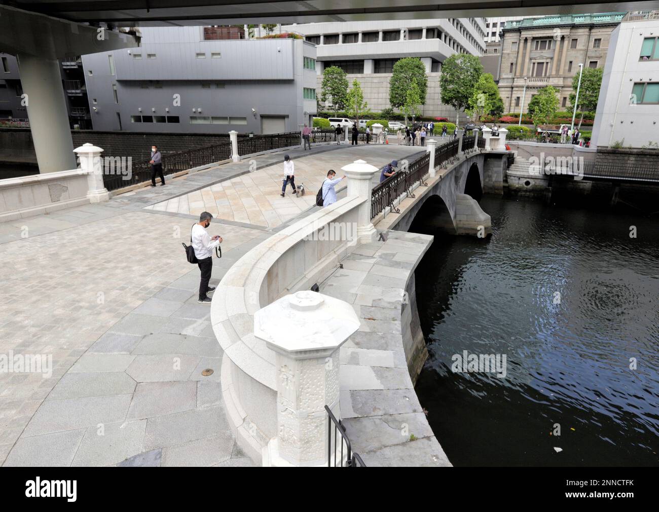Pedestrians walk on the Tokiwa Bridge, which has been renovated after a ...