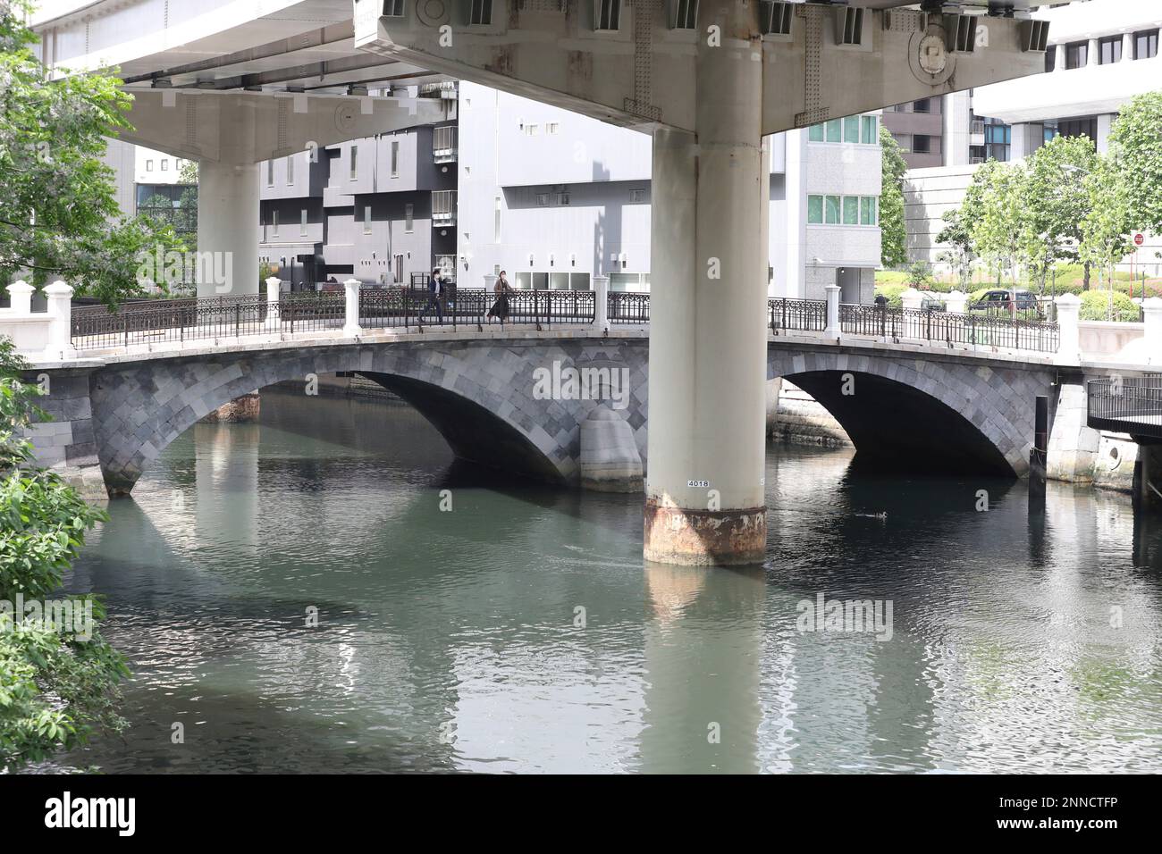 Pedestrians walk on the Tokiwa Bridge, which has been renovated after a ...