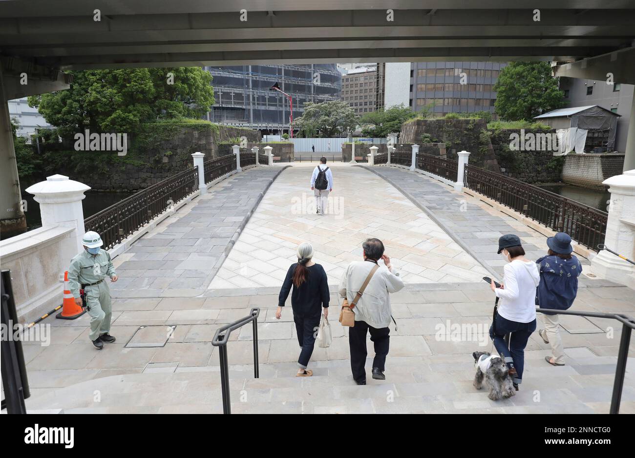 Pedestrians walk on the Tokiwa Bridge, which has been renovated after a damage from the 2011 ...