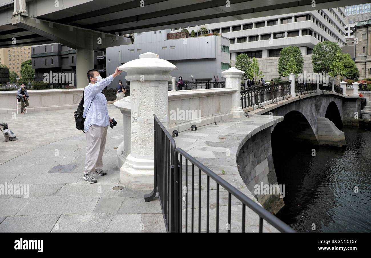 Pedestrians walk on the Tokiwa Bridge, which has been renovated after a ...