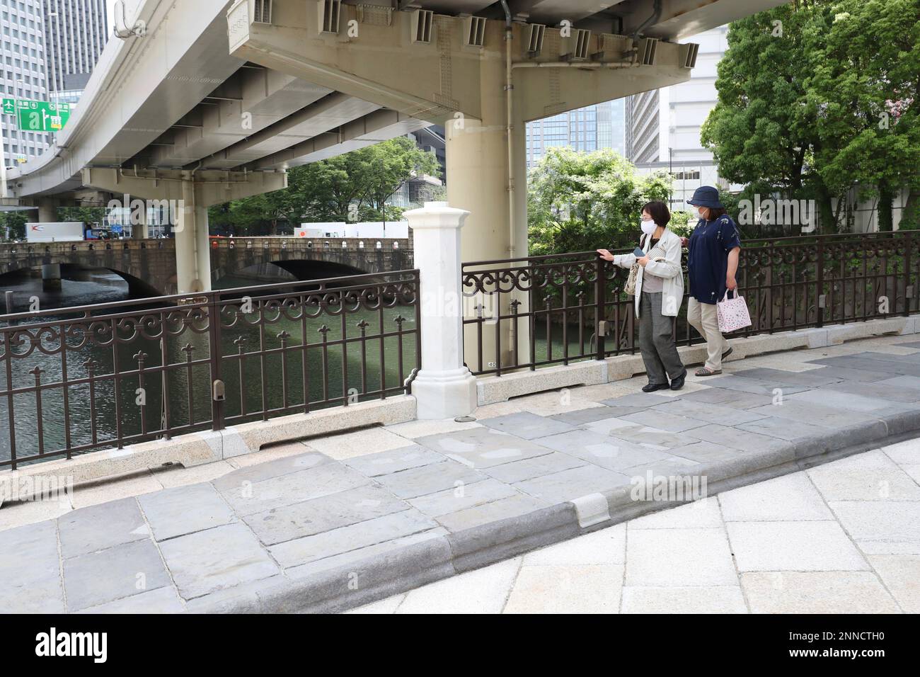 Pedestrians walk on the Tokiwa Bridge, which has been renovated after a damage from the 2011 ...