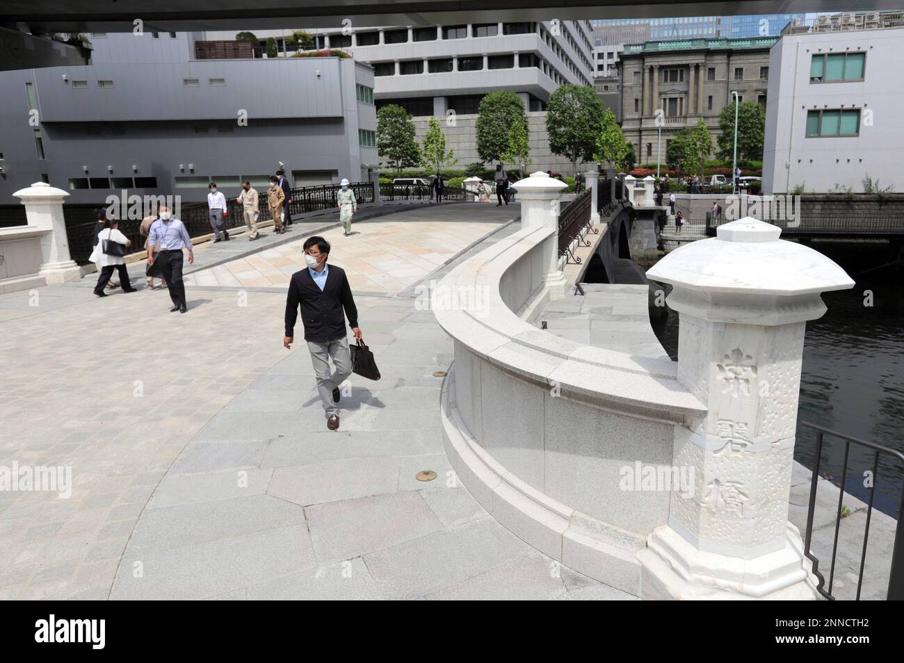 Pedestrians walk on the Tokiwa Bridge, which has been renovated after a ...