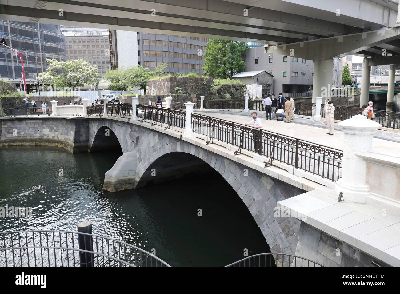 Pedestrians walk on the Tokiwa Bridge, which has been renovated after a ...