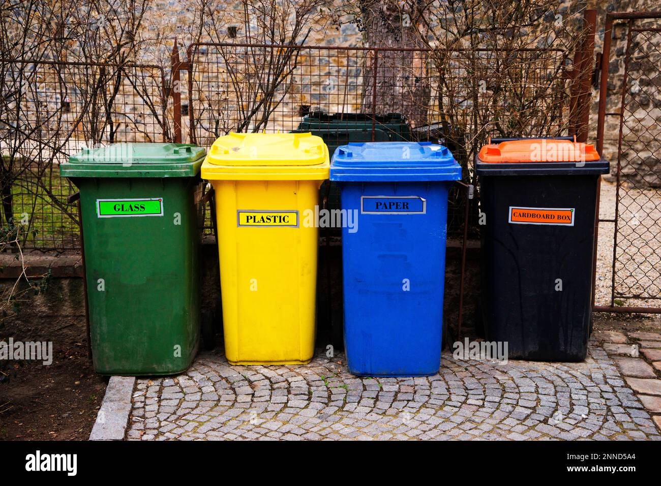 multi-colored plastic garbage containers for different garbage are on ...