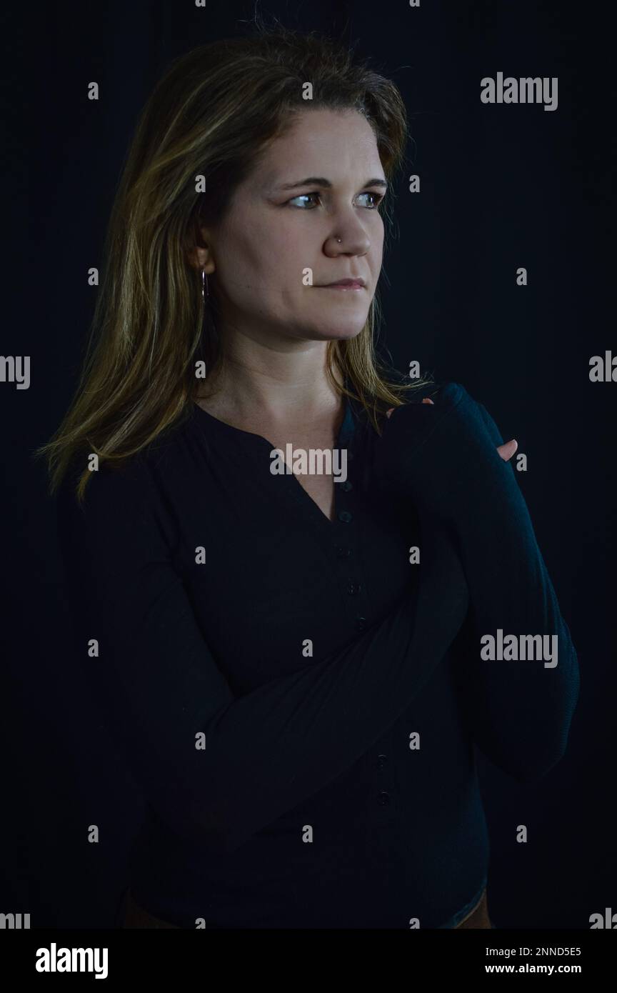 portrait of a beautiful elegant blonde woman with her hands together ...