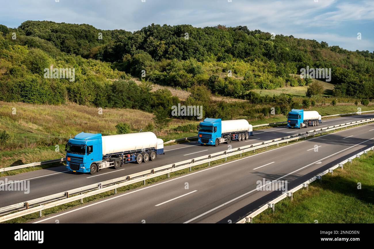 Convoy or Fleet of Tank trucks on a Highway through the rural landscape ...