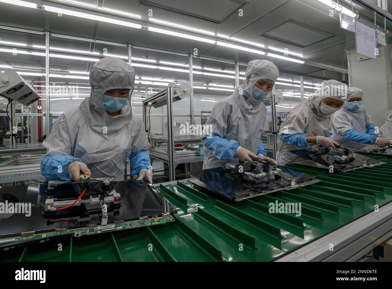 Workers assemble flat screens at a plant of TPV Display Technology in ...